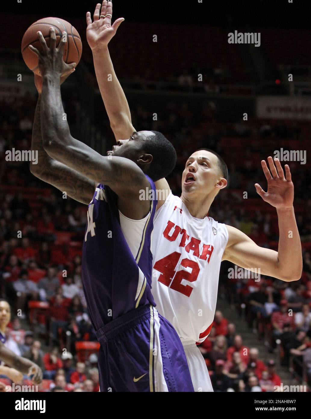 Washington guard Tony Wroten (14) gets past Utah center Jason Washburn ...