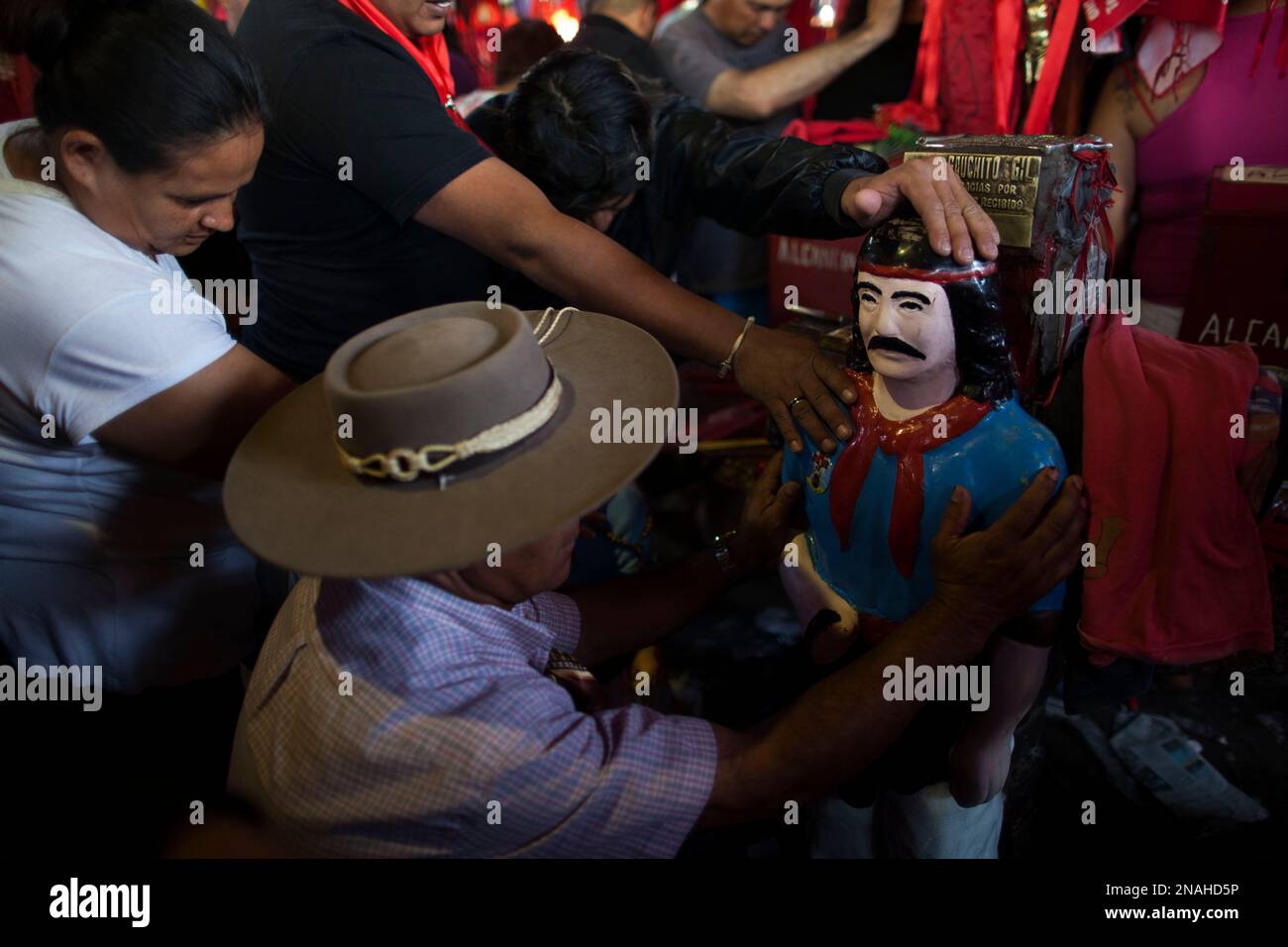 Faithful touch a statue of 'Gauchito Gil' at his sanctuary a day before ...