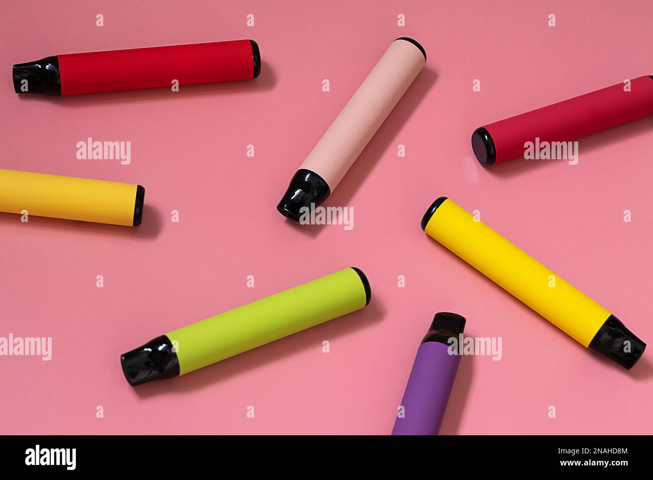 Layout of colorful disposable vapor stick on a light background ...