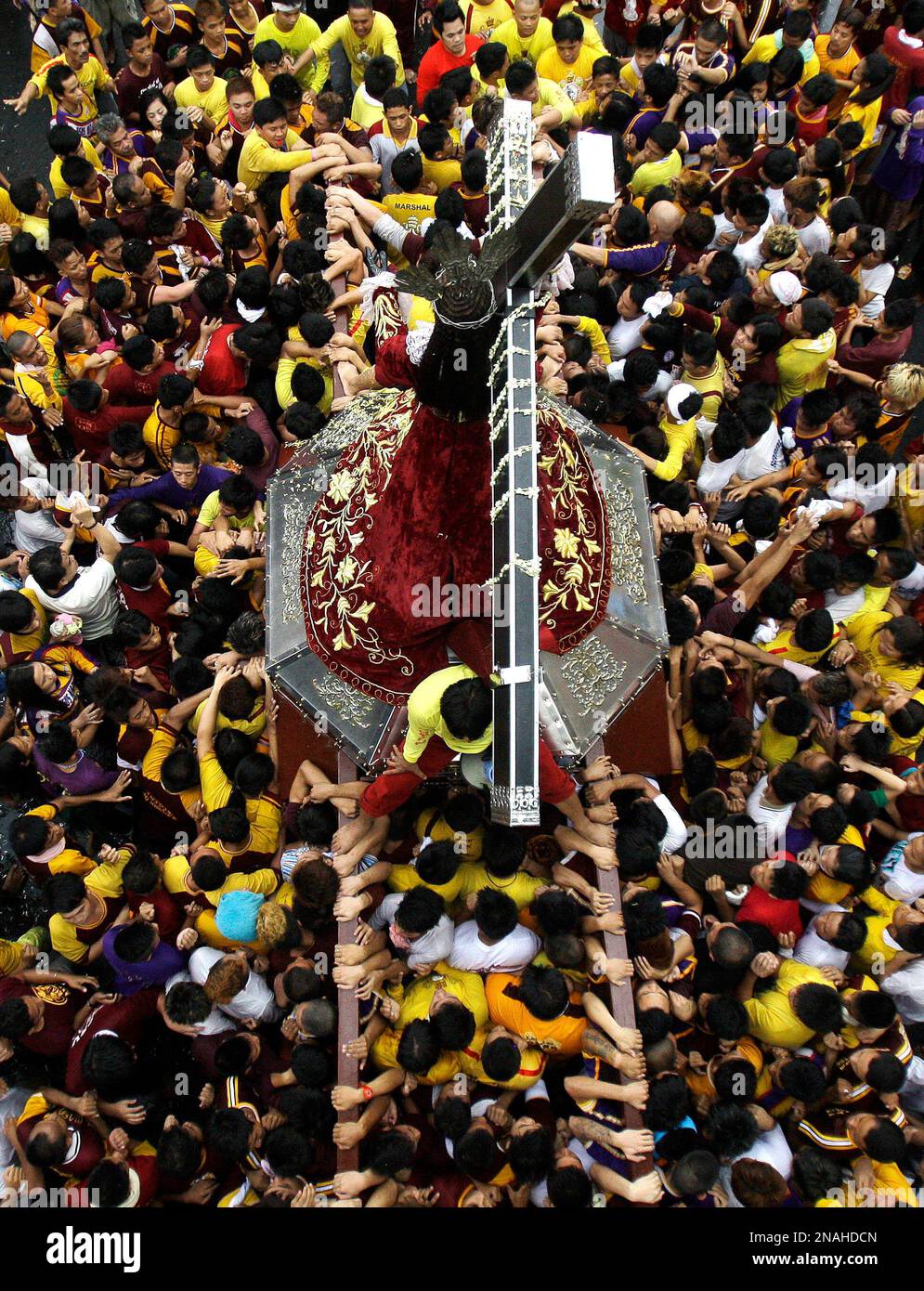 Filipino devotees surround a replica of a centuries-old black statue of ...