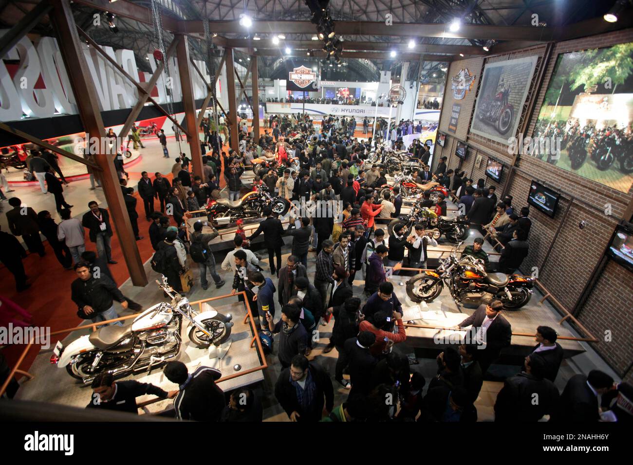 Visitors crowd the Harley Davidson motorcycle stall at a press preview ...