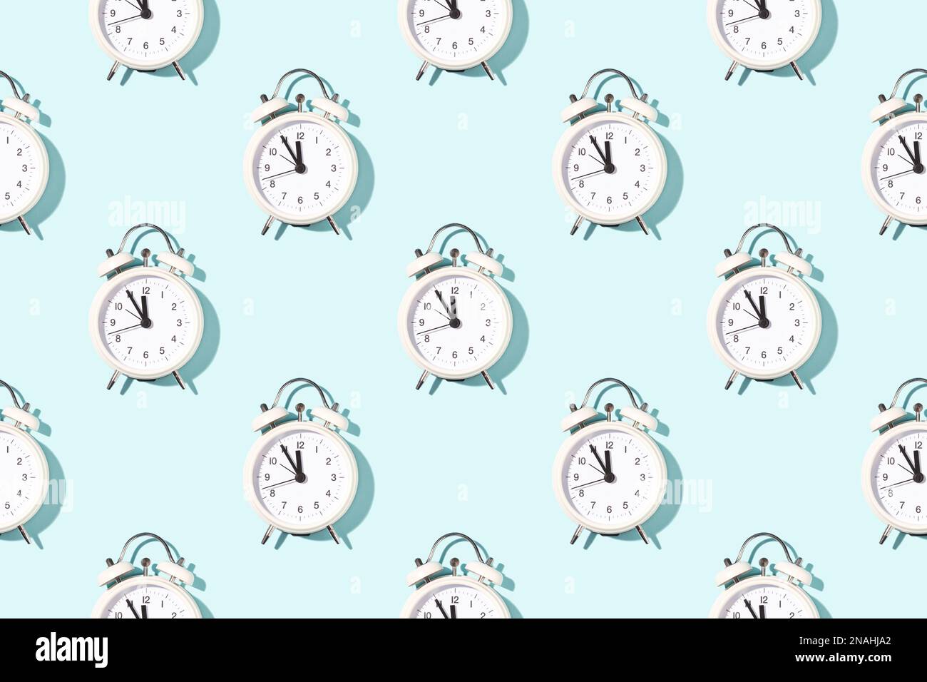 Seamless pattern of white alarm clocks on bright light blue background ...