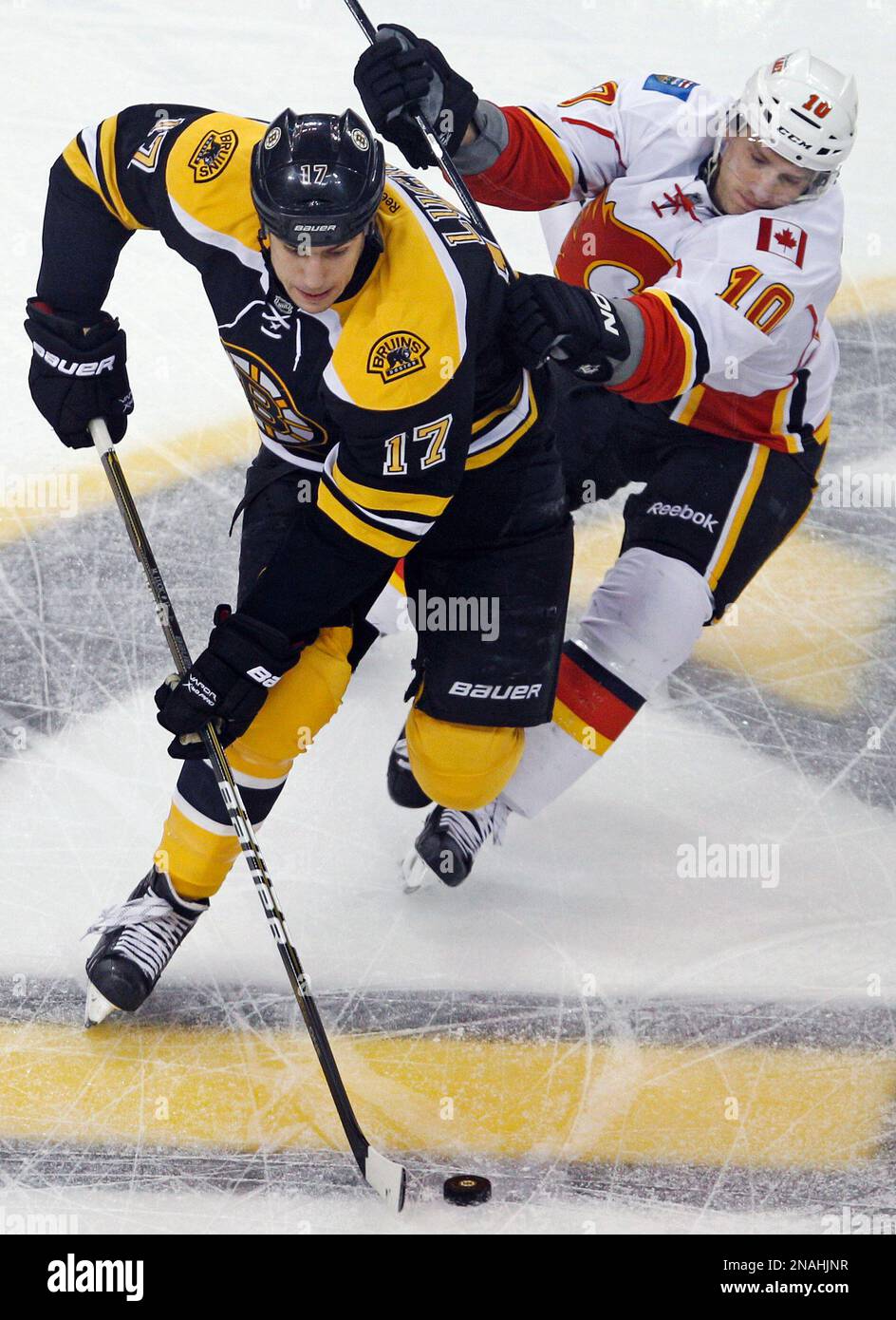 Boston Bruins left wing Milan Lucic (17) handles the puck away from ...