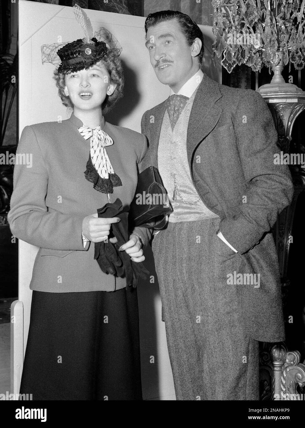 Myrna Loy visiting on a movie set with Walter Pidgeon acting as host in ...