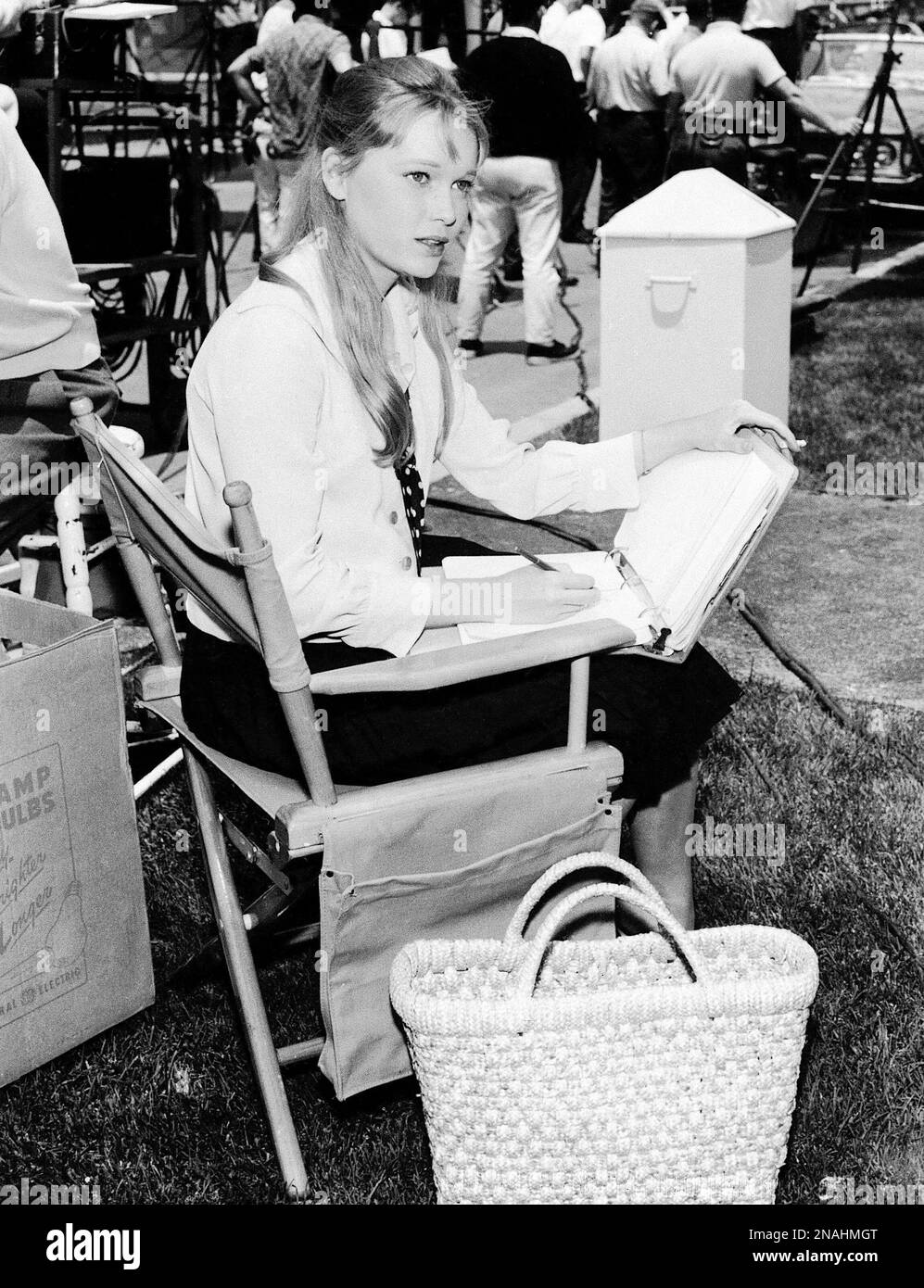 Waiting to go before the cameras, Mia Farrow does some sketching on the ...