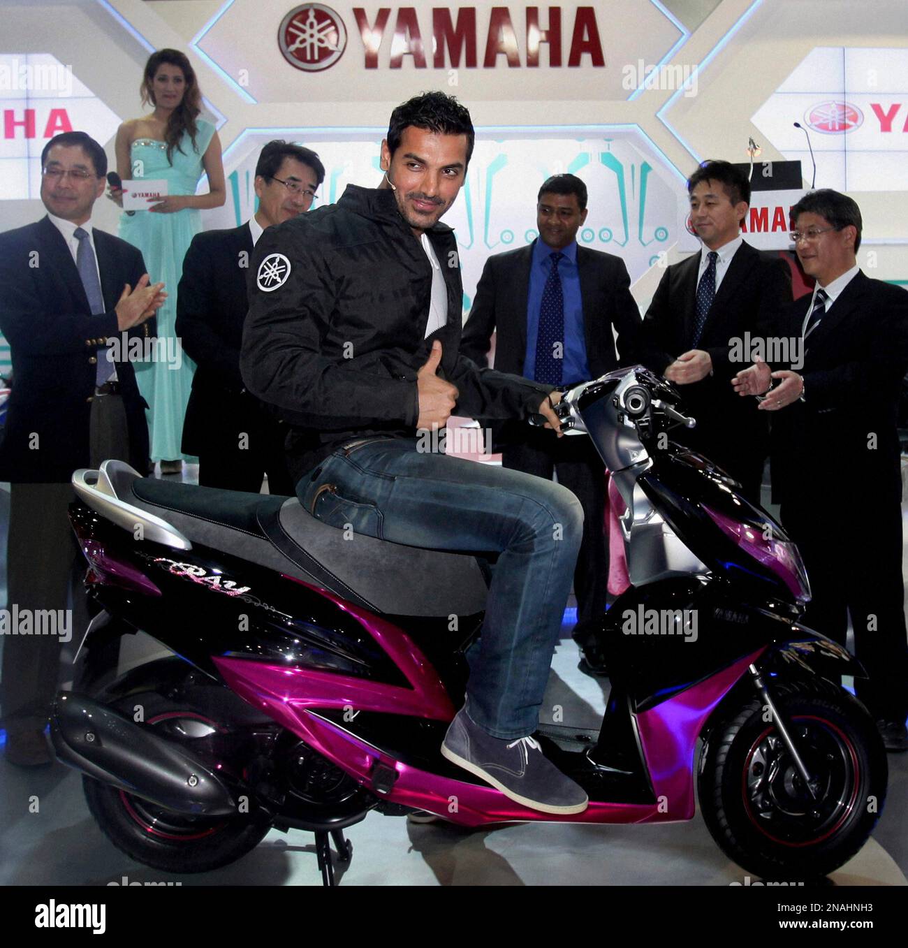 Indian actor John Abraham poses with a Yamaha Scooter Prototype model ...