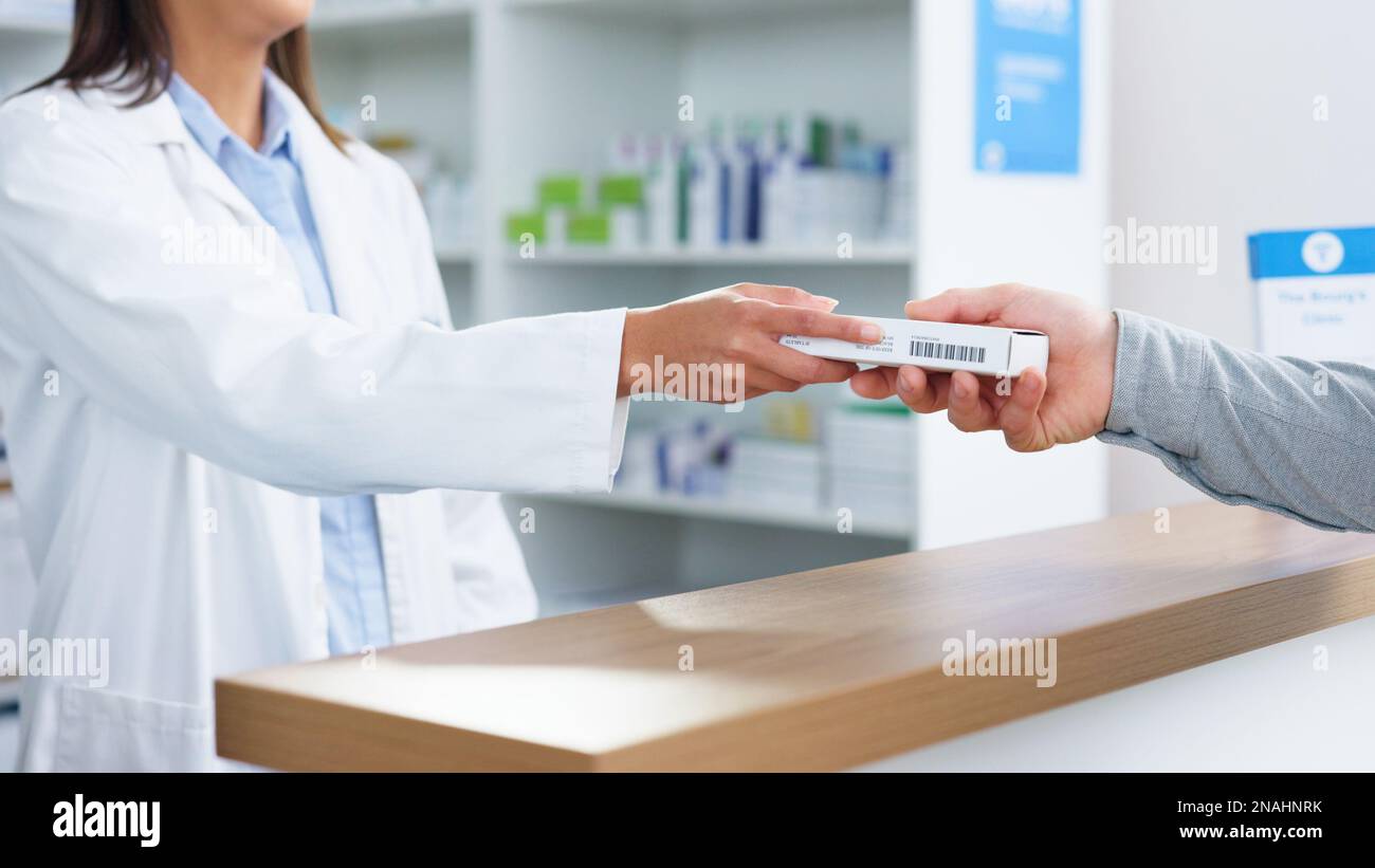 Talking pharmacist explaining medication to patient in clinic pharmacy ...