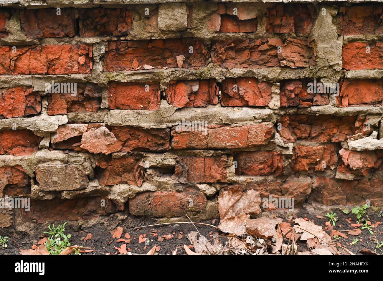 red brick wall collapses from old age. broken brick wall Background ...