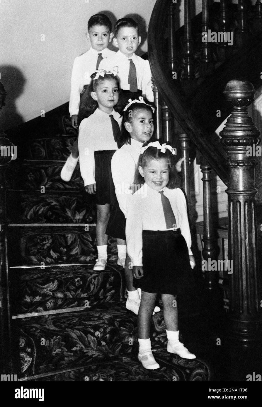 The Diligenti quintuplets stand on the steps inside their Buenos Aires ...
