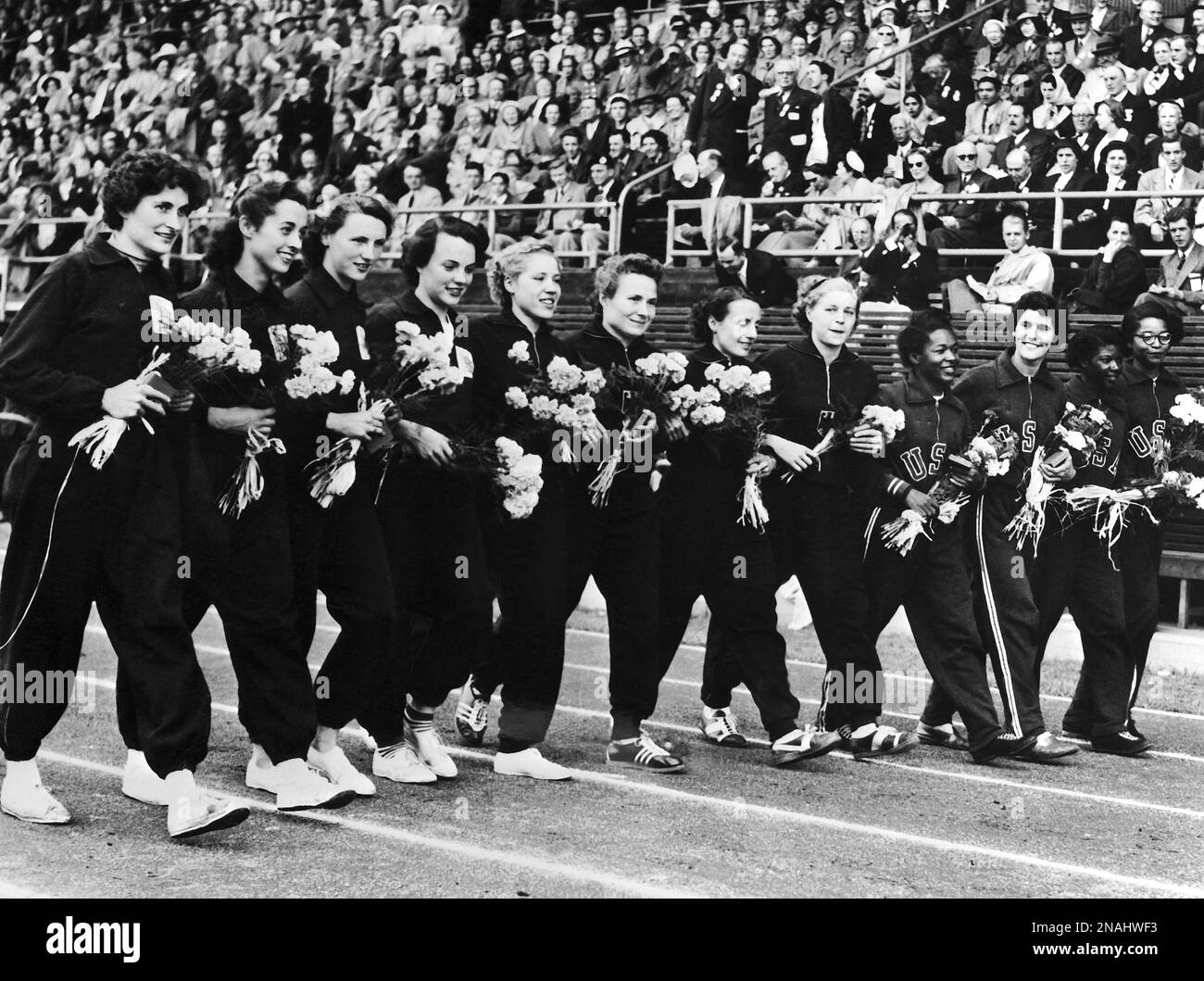 Members of the winning women's 4 x 100 meters relay teams walk arm in ...