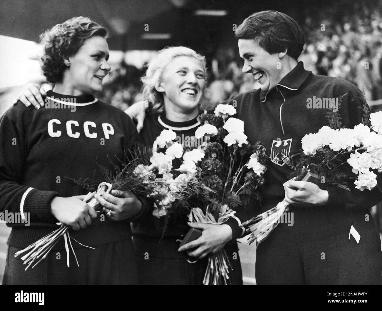 Embracing and smiling to each other are the winners of the Women's shot ...