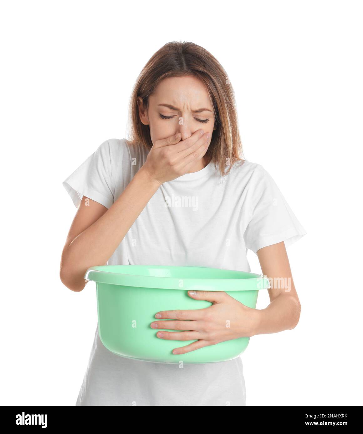Woman with basin suffering from nausea on white background. Food ...