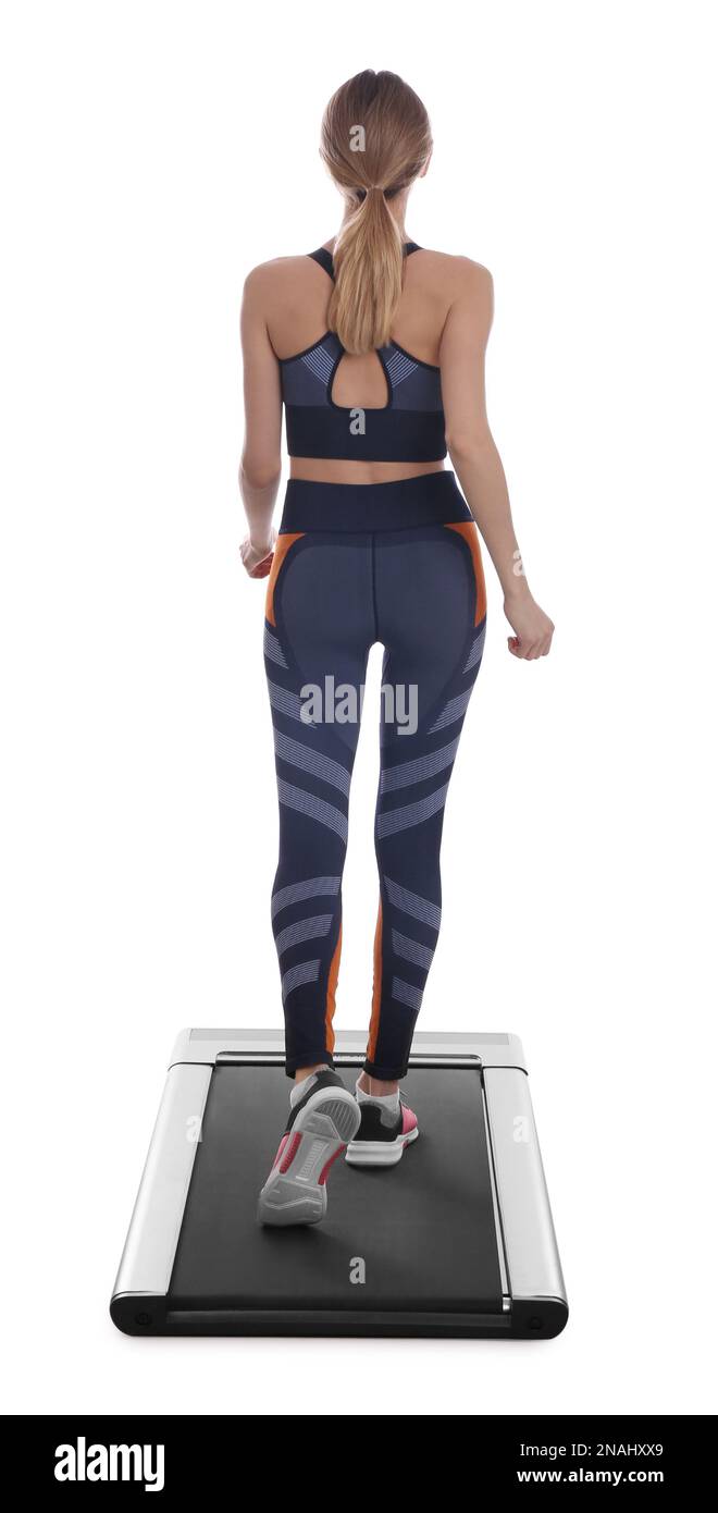 Sporty woman using walking treadmill on white background, back view ...