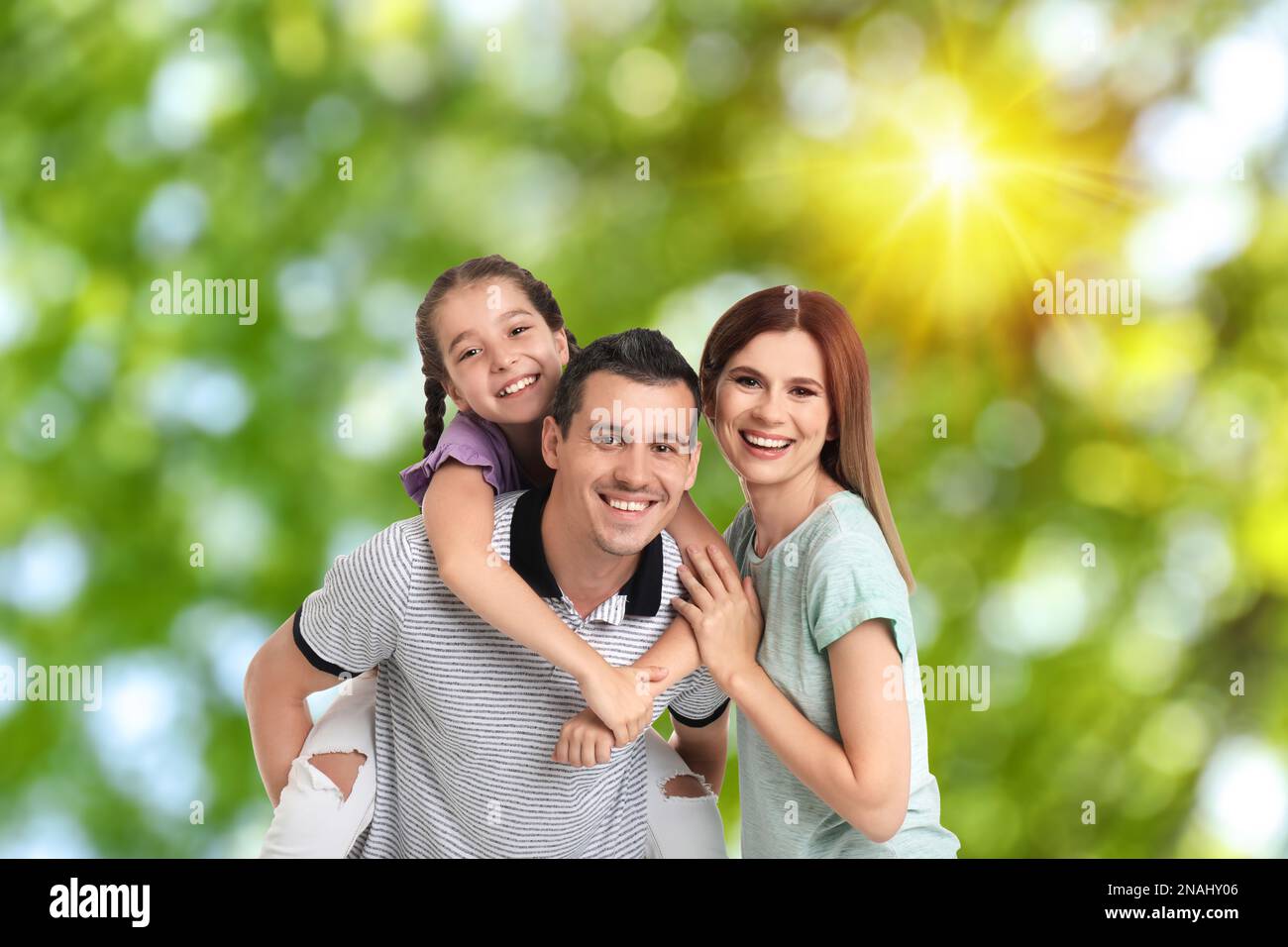 Happy family with child outdoors on sunny day Stock Photo - Alamy