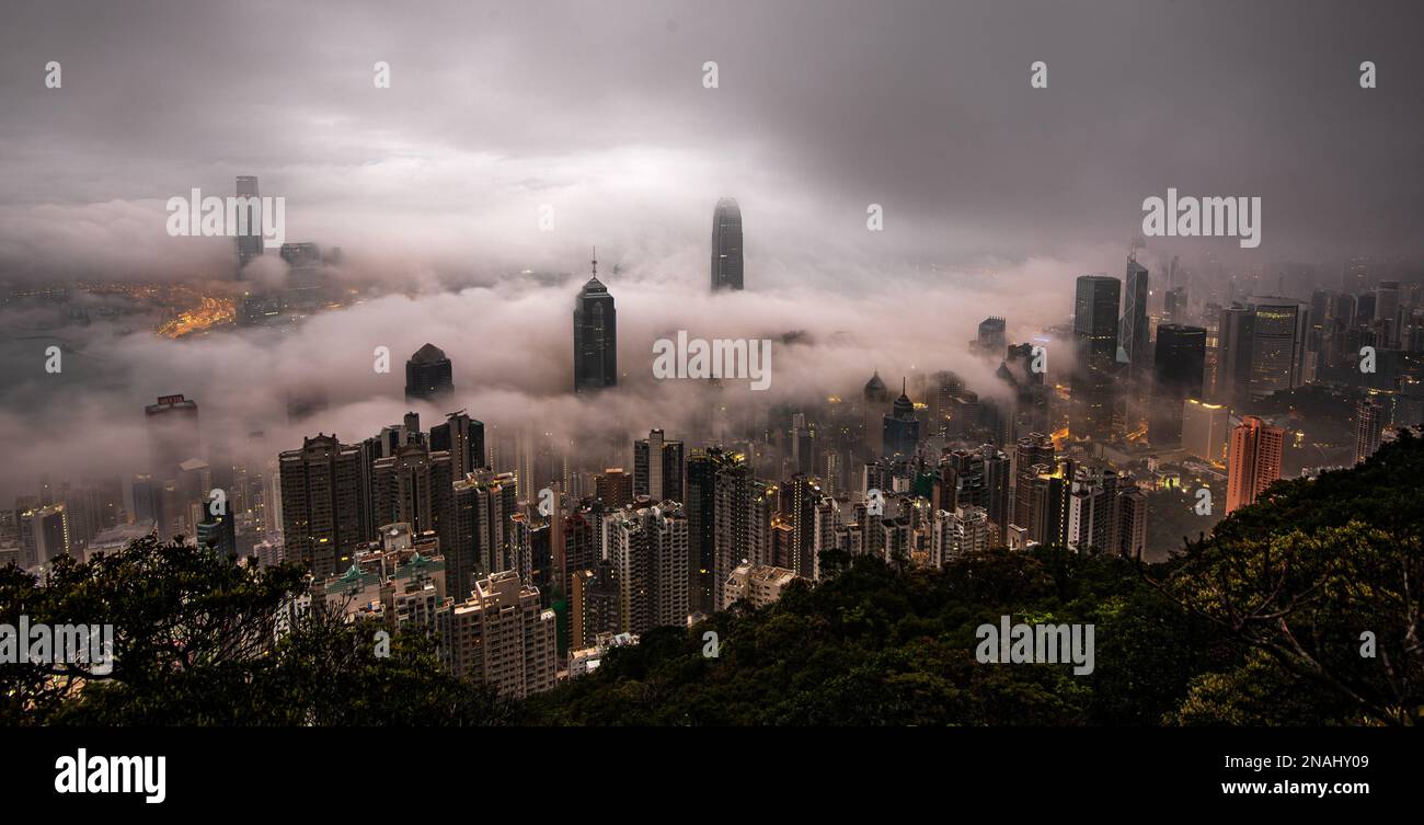 The skyscrapers of a city covered in mist Stock Photo - Alamy