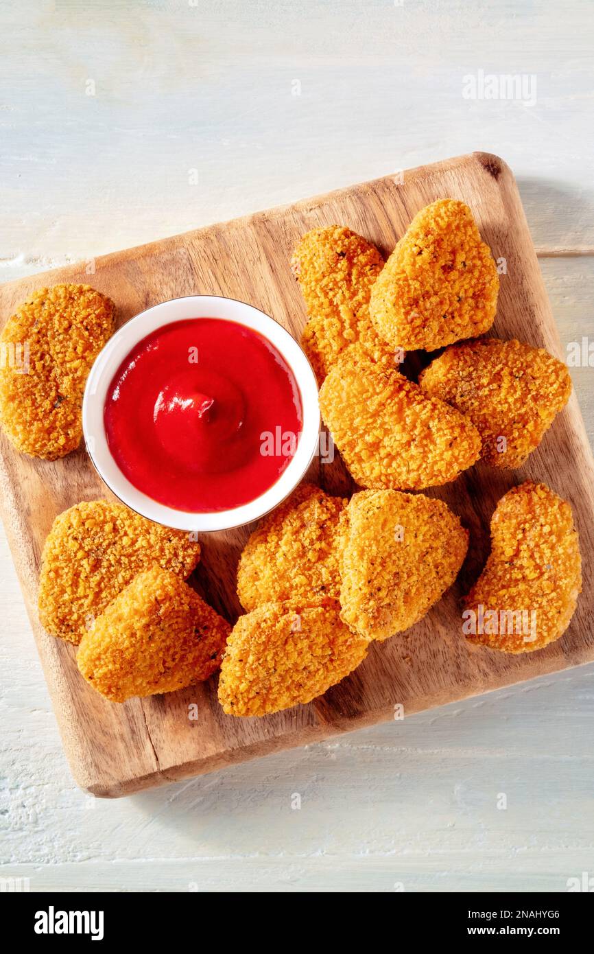 Chicken nuggets with bbq sauce on a rustic wooden background, top shot ...
