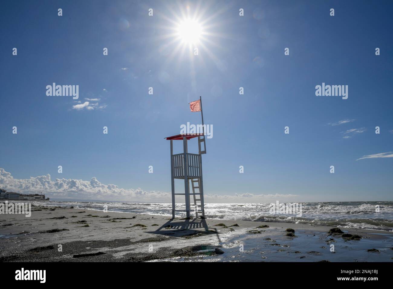 Red flag on a high seat of the naval guard, Grado Island, Friuli ...