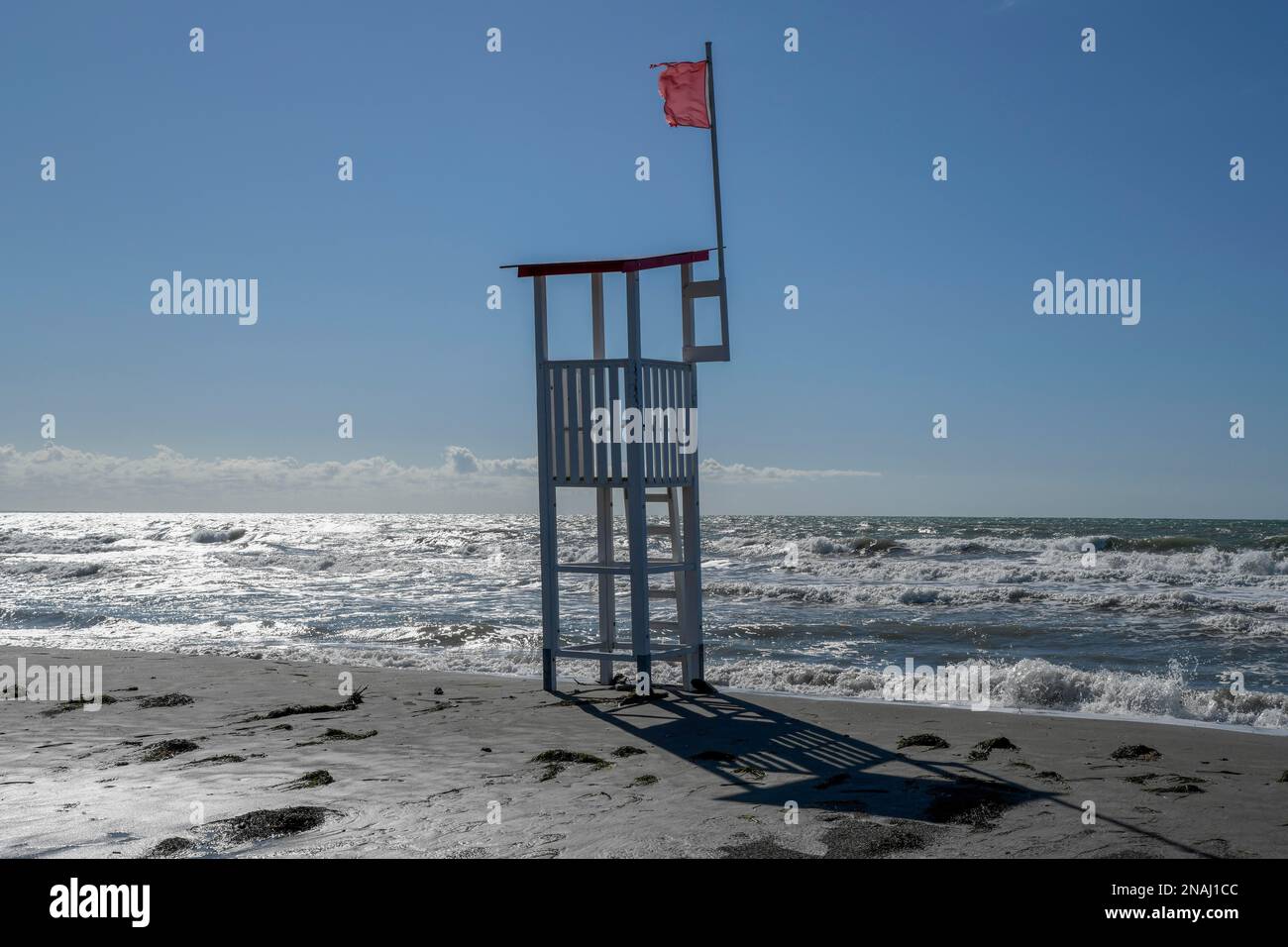 Red flag on a high seat of the naval guard, Grado Island, Friuli ...