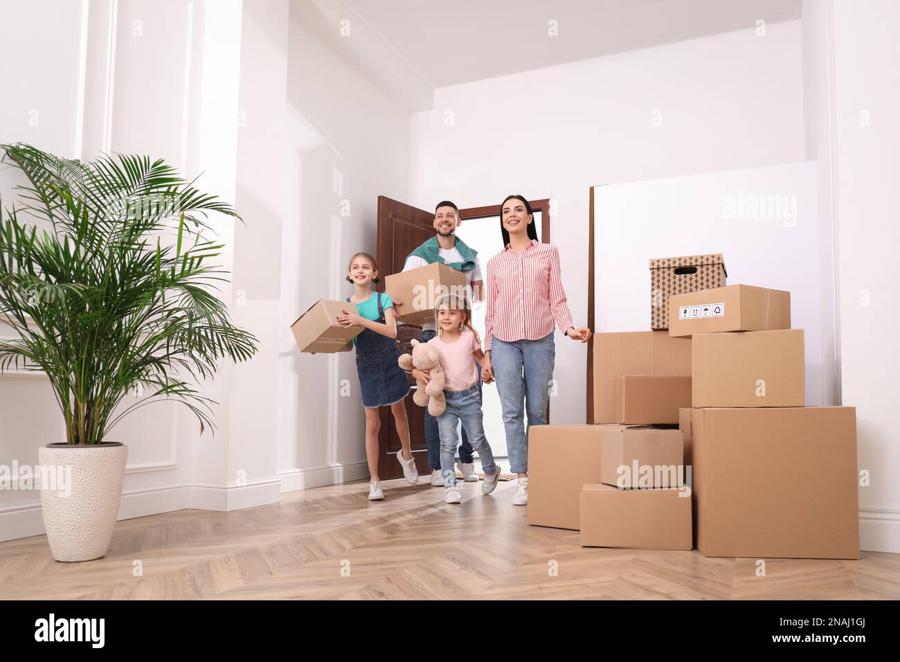 Happy family with children moving into new house Stock Photo - Alamy