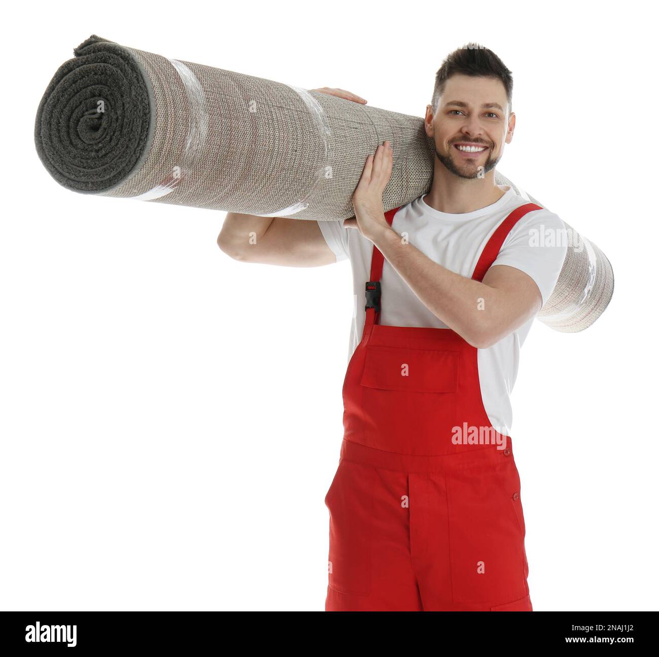 Male worker with rolled carpet on white background Stock Photo - Alamy