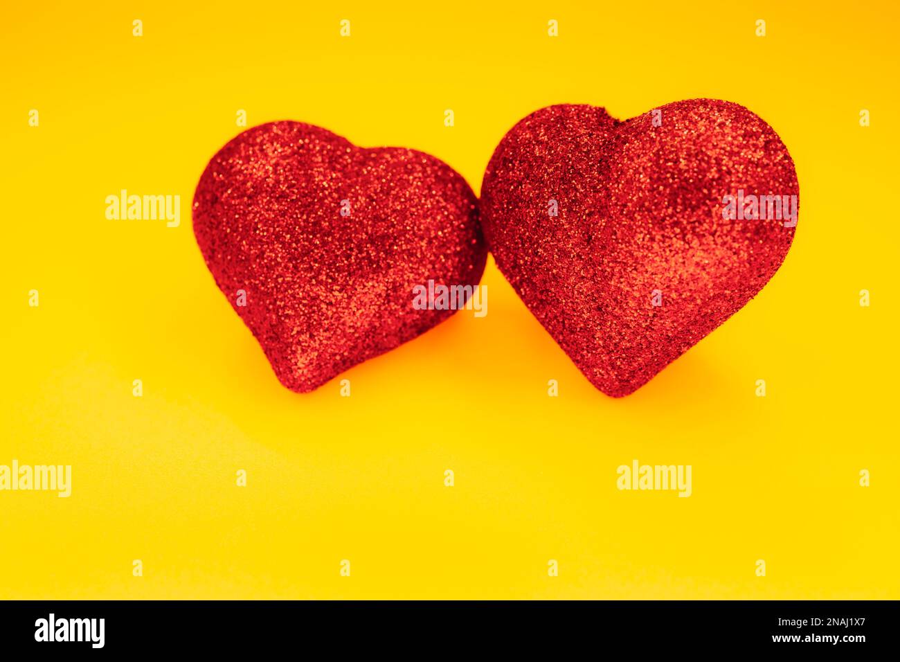 two hearts shape on the yellow background Stock Photo - Alamy