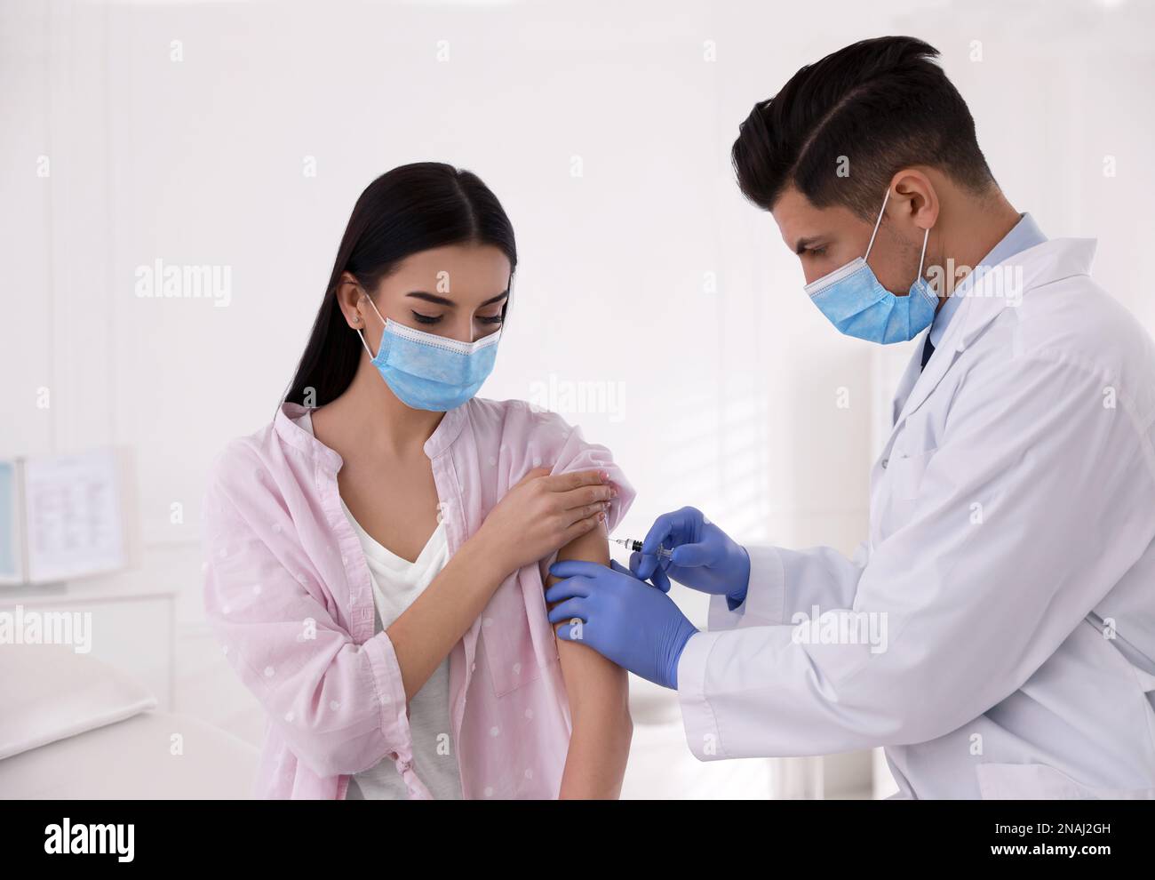 Doctor giving injection to patient in hospital. Vaccination campaign ...