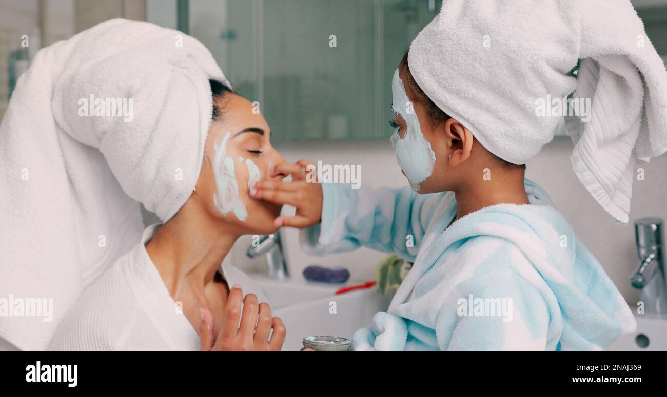 Family, facial and mask with mother in bathroom with young child using ...