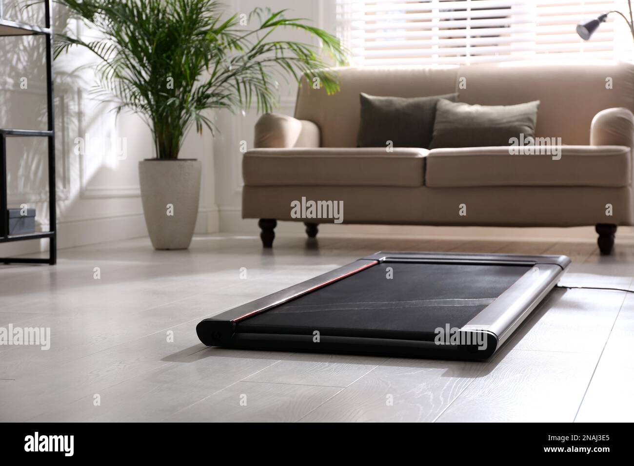 Modern walking treadmill in living room. Home gym equipment Stock Photo ...