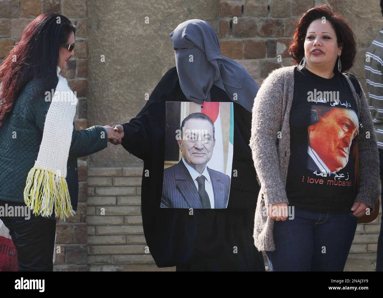 Two Egyptian pro-regime women shake hands as they demonstrate their ...