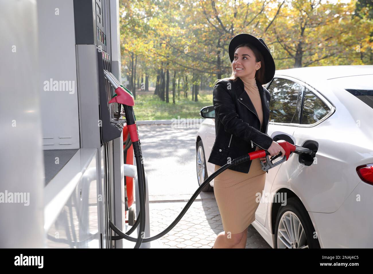 Woman refueling car at self service gas station Stock Photo - Alamy