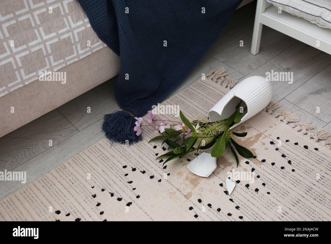 Broken vase and bouquet on floor in room Stock Photo - Alamy