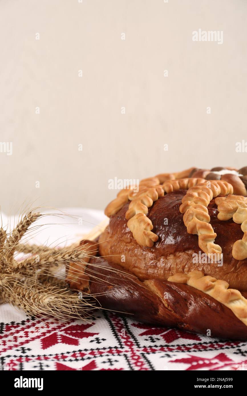 Rushnyk with korovai on light background, space for text. Ukrainian ...