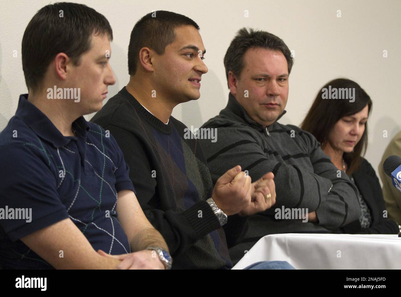 Rescuers Buzzy Mullahkhel, second from left, and Erik Schaelling, left ...