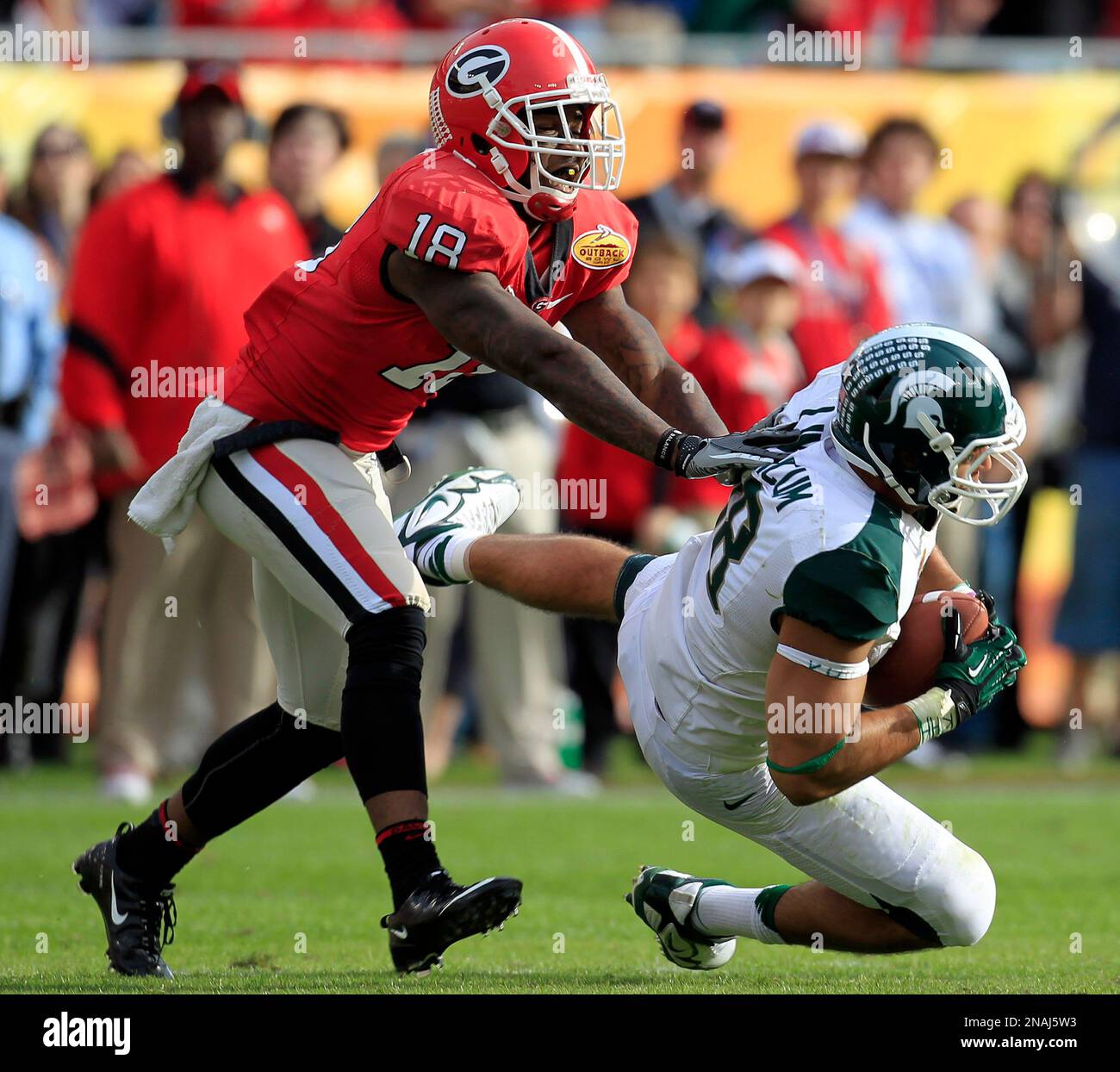 Michigan State tight end Brian Linthicum (88) is knocked down by ...