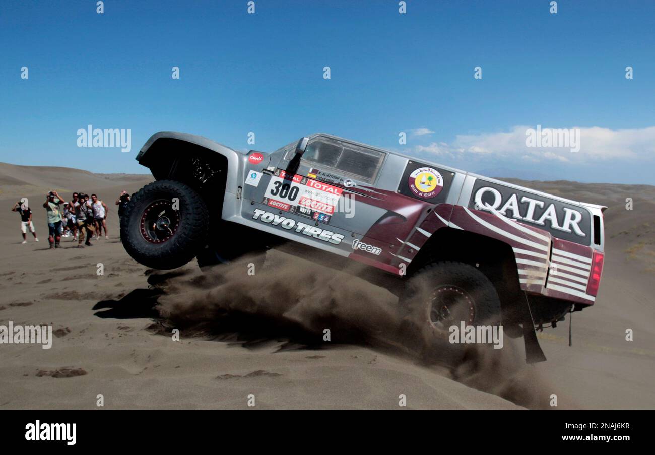 Hummer driver Nasser Al-Attiyah from Qatar and co-driver Cruz Luca from ...
