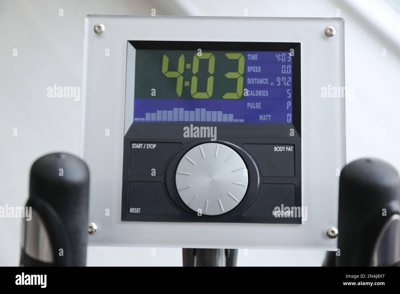 Control panel of modern elliptical machine cross trainer on blurred ...