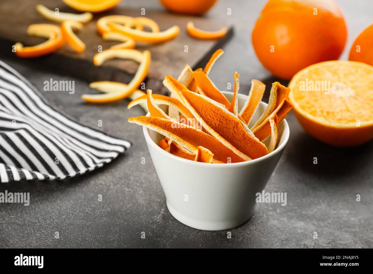 Dry orange fruit peels on grey table Stock Photo - Alamy