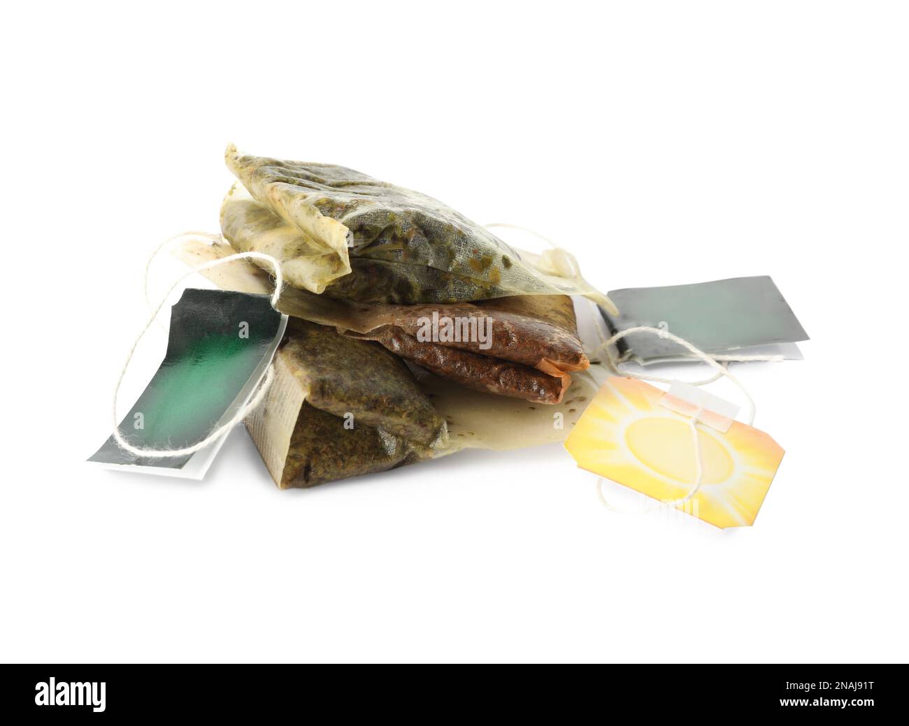 Used tea bags with tags on white background Stock Photo - Alamy