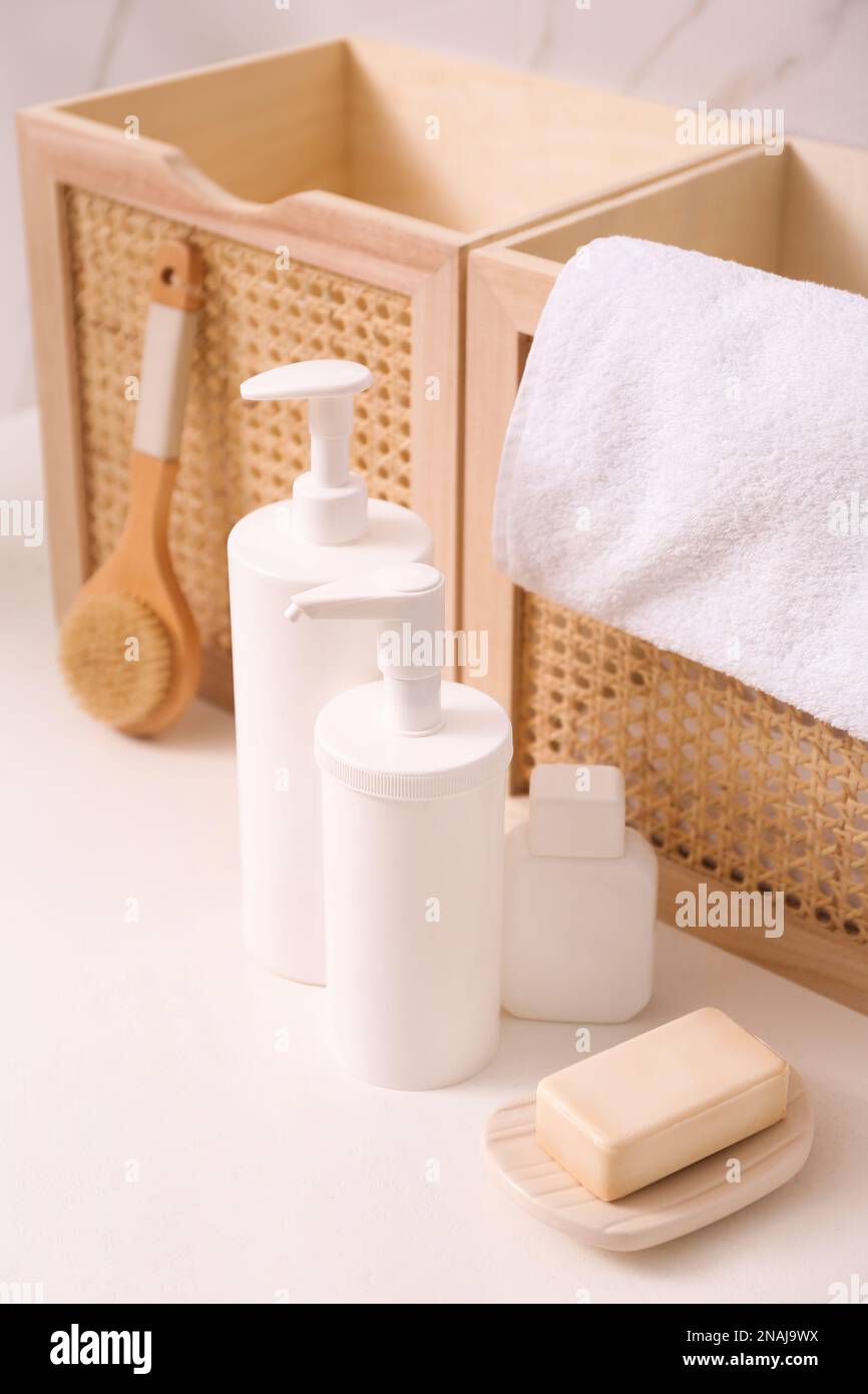 Toiletries and personal hygiene products on white table in bathroom ...