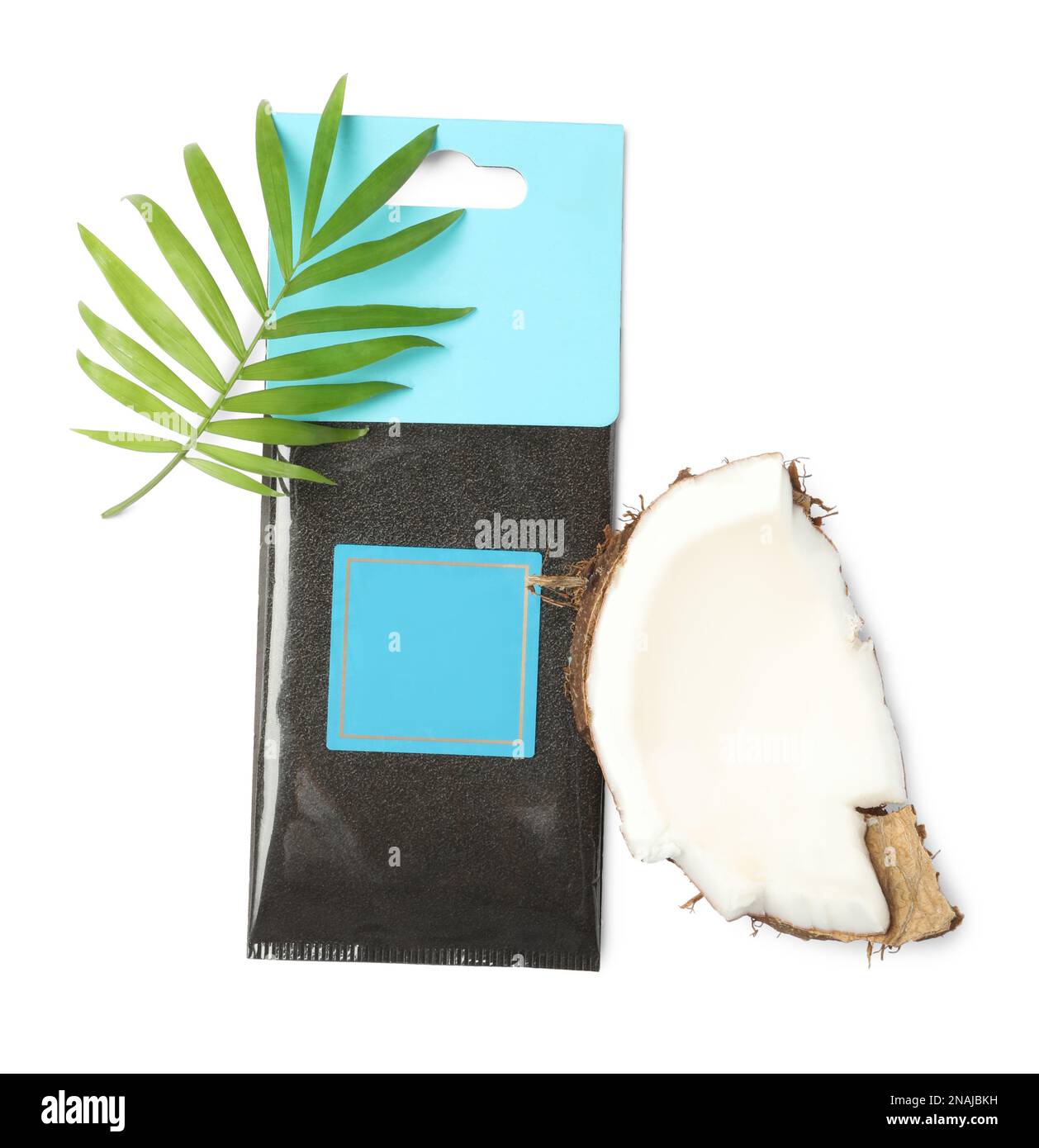 Scented sachet, green leaf and piece of coconut on white background ...