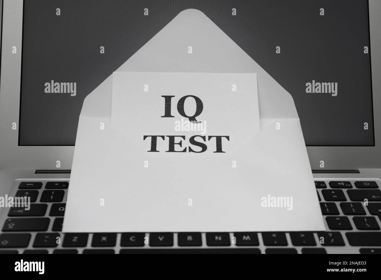 Paper with words IQ Test in envelope on laptop Stock Photo - Alamy