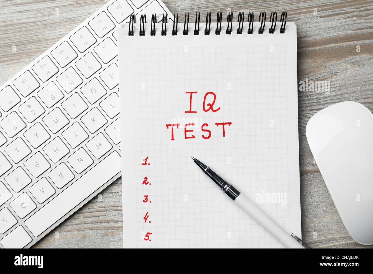 Notebook with words IQ Test, pen and keyboard on wooden table, flat lay ...