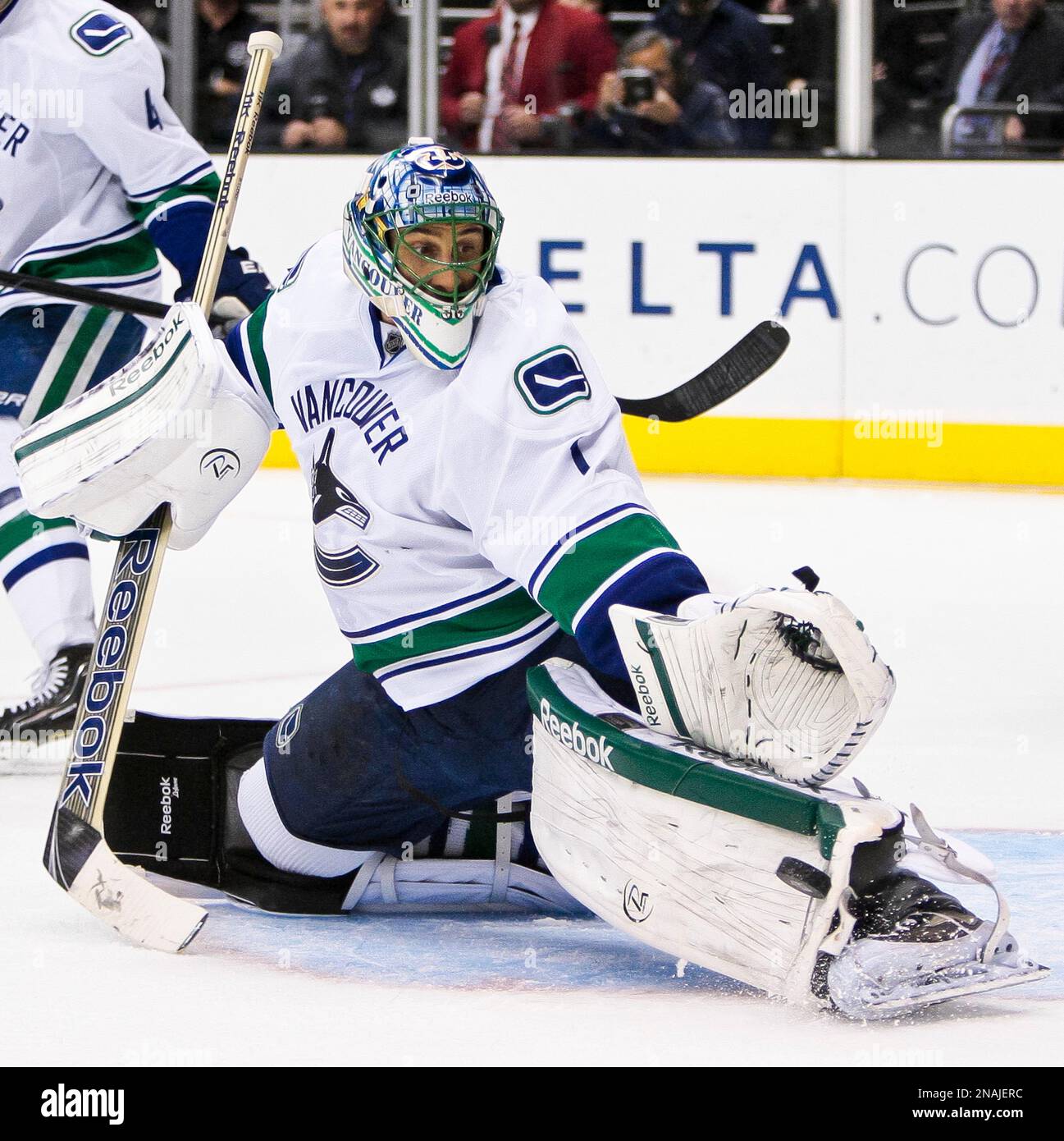 Vancouver Canucks goalie Roberto Luongo makes a kick save during the ...