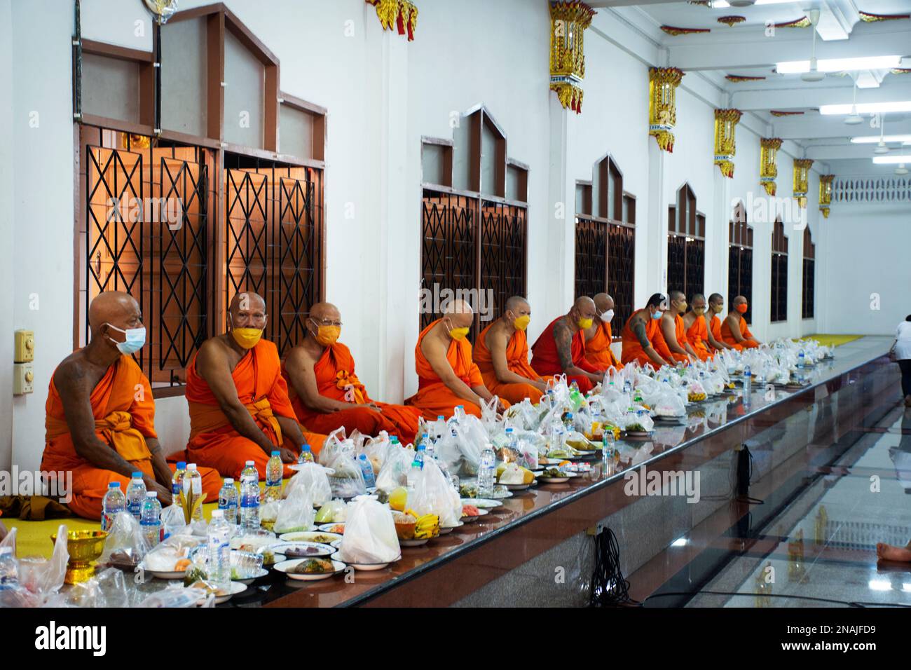Monks sitting between thai people join tradition make merit offer food ...