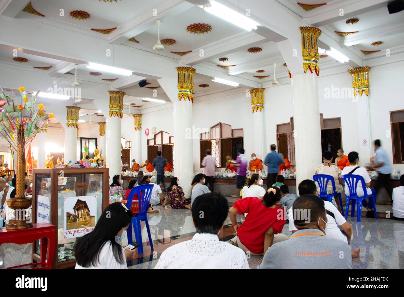 Monks sitting between thai people join tradition make merit offer food ...