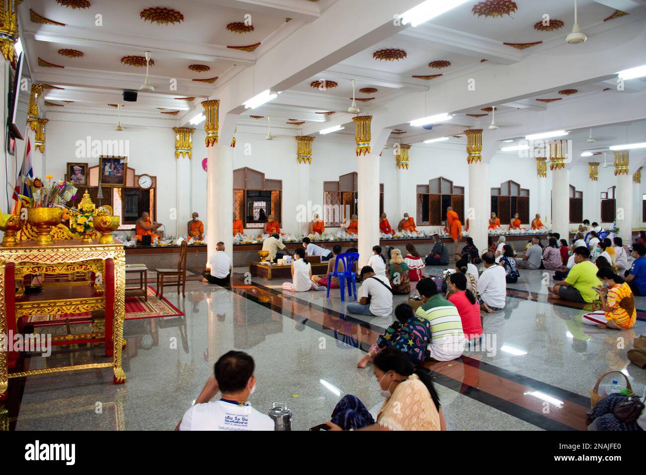 Monks sitting between thai people join tradition make merit offer food ...