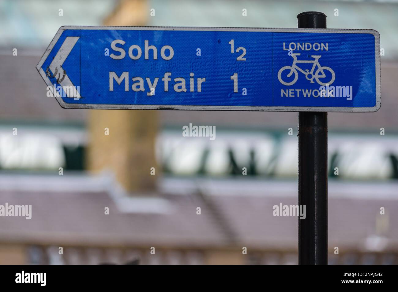 A street sign in London directs cyclists towards Mayfair and Soho along ...