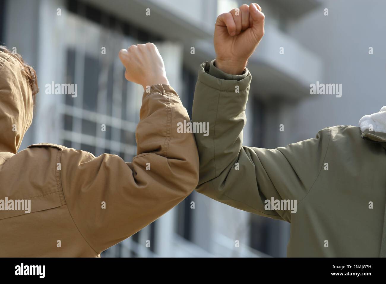 People greeting each other by bumping elbows instead of handshake ...