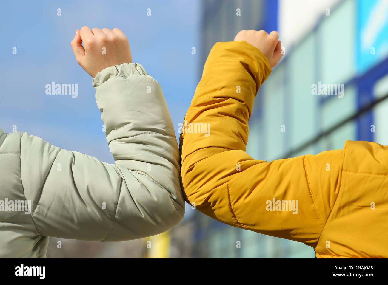 People greeting each other by bumping elbows instead of handshake ...