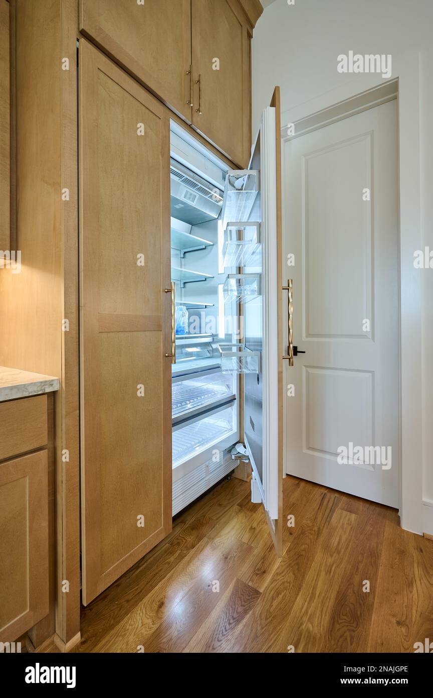 Open Refrigerator Door in Contemporary Kitchen Built In Cabinetry Stock ...